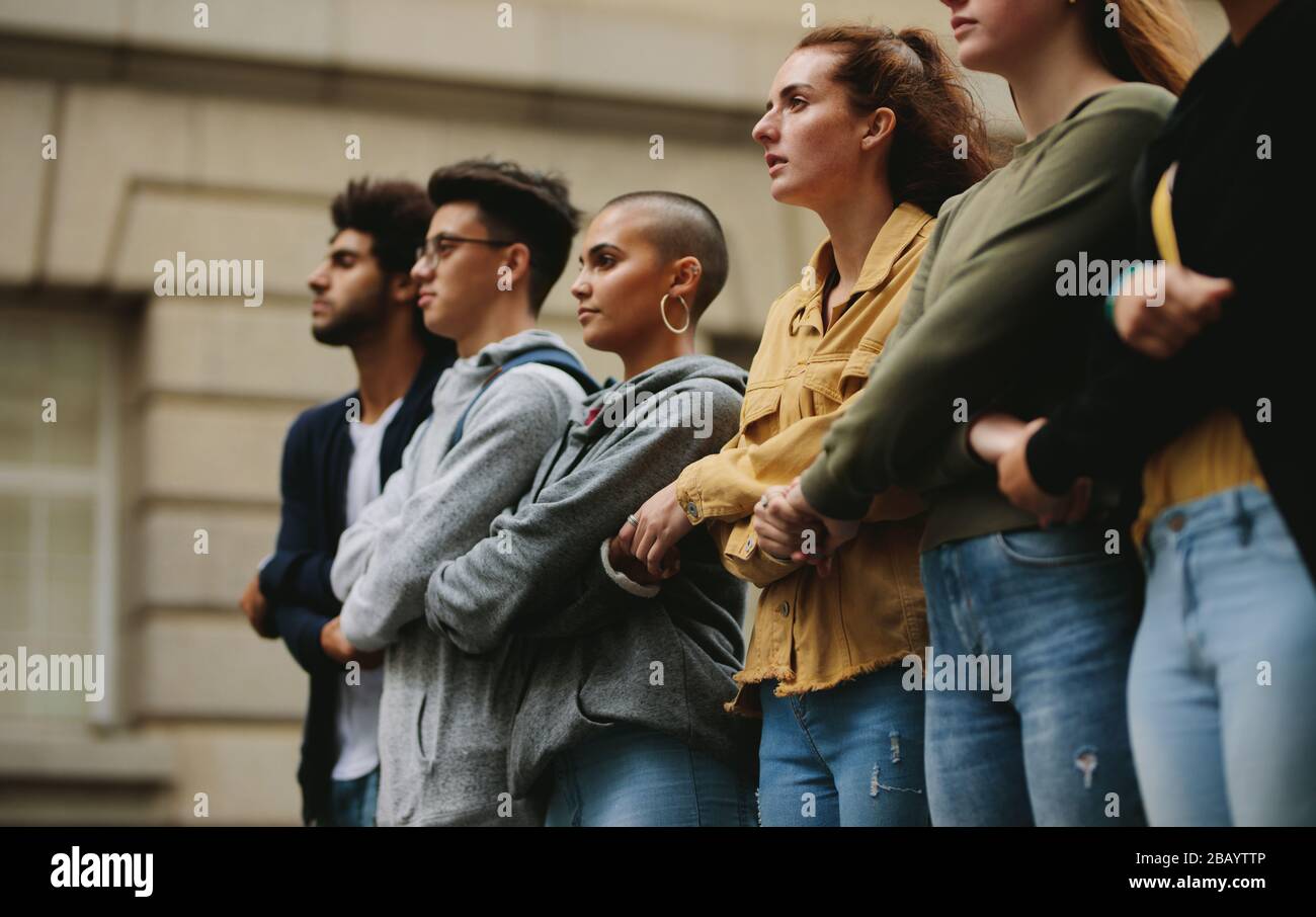 Group of activists standing together holding hands in protest picket ...