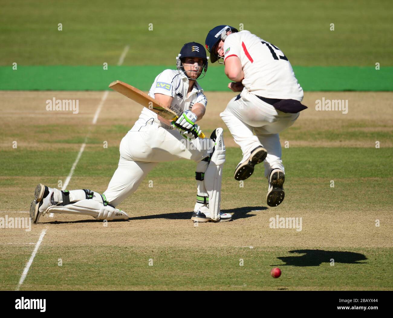 Middlesex's Dawid Malan strikes the ball past Lancashire's Steven Croft ...