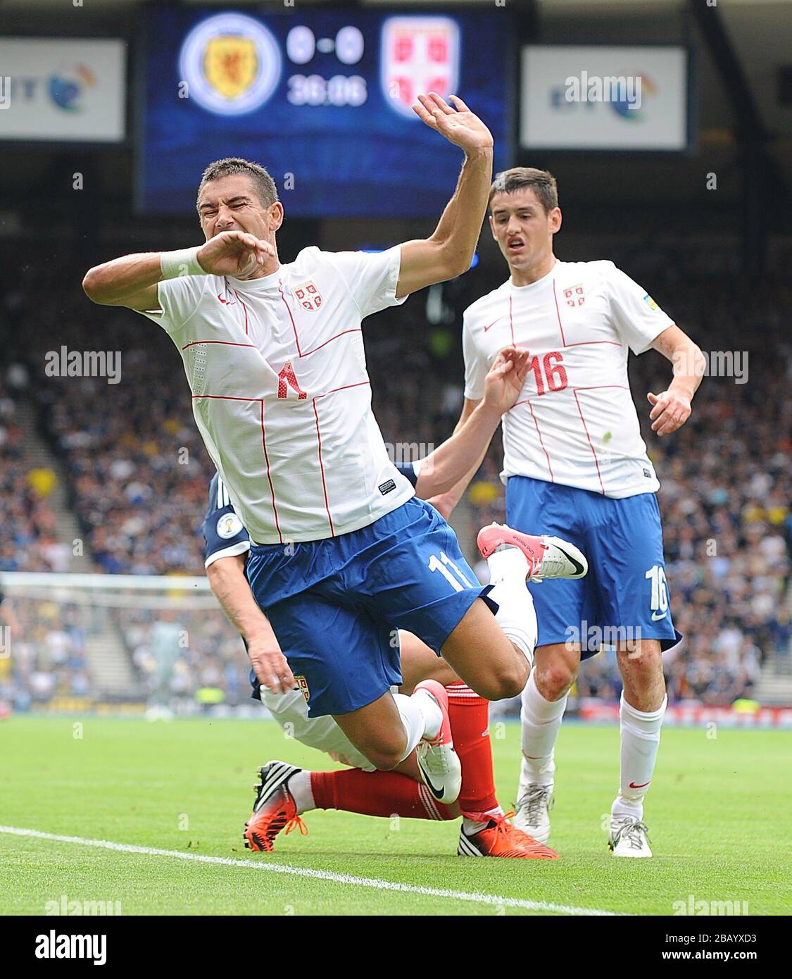 Serbia's Aleksandar Kolarov (left) is brought down by Scotland's ...