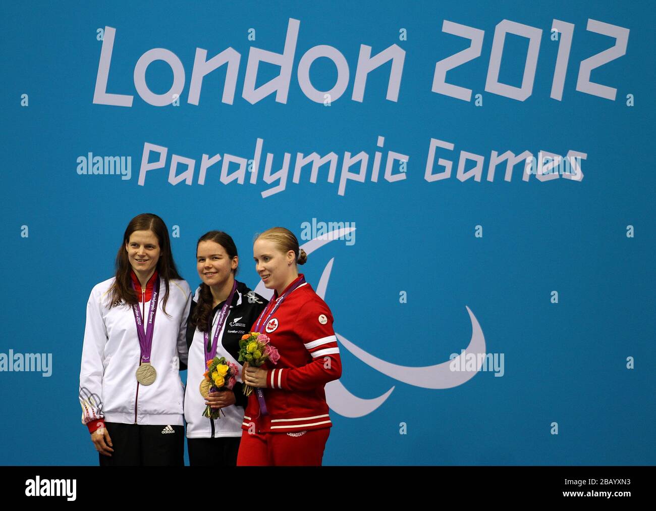 New Zealand's Mary Fisher (centre) on the podium with her gold medal ...