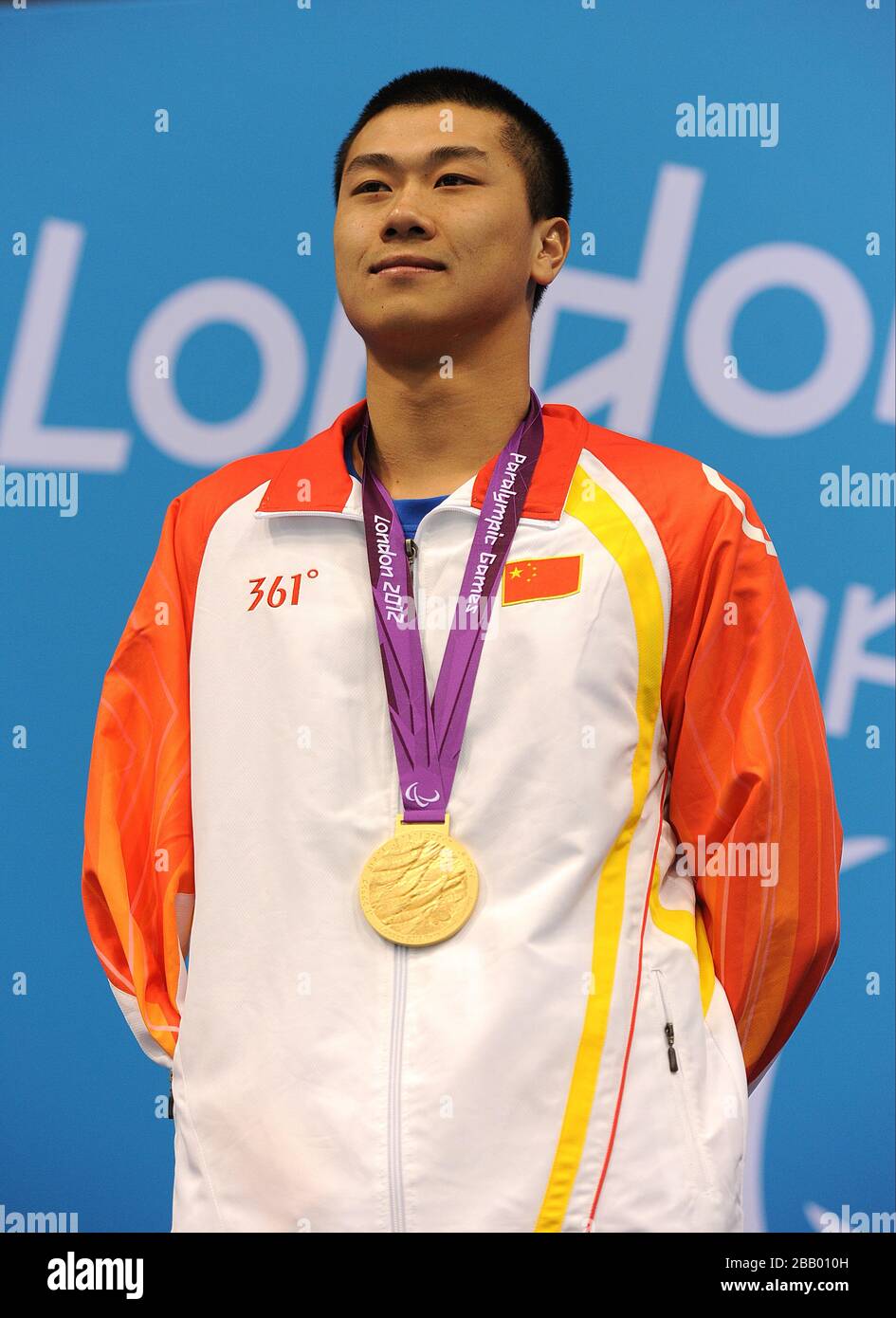 China's Shiyun Pan celebrates on the podium with his gold medal in the ...