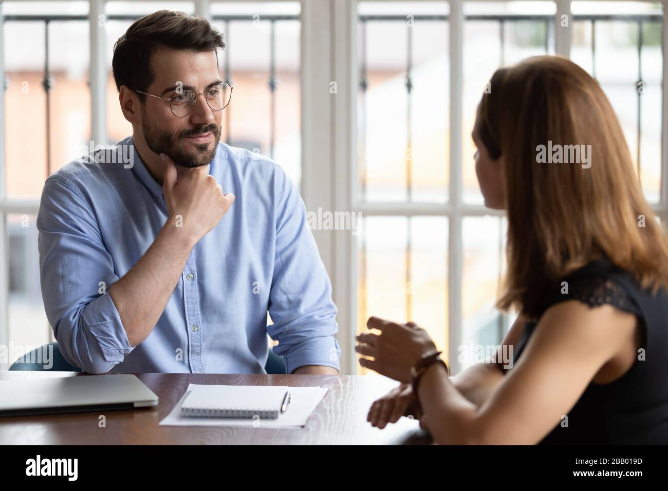 HR manger listening female applicant during job interview Stock Photo ...