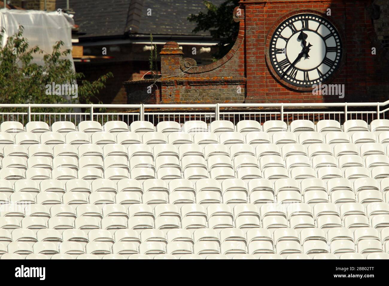 Rows of empty seats in front of the Lord's clock Stock Photo - Alamy