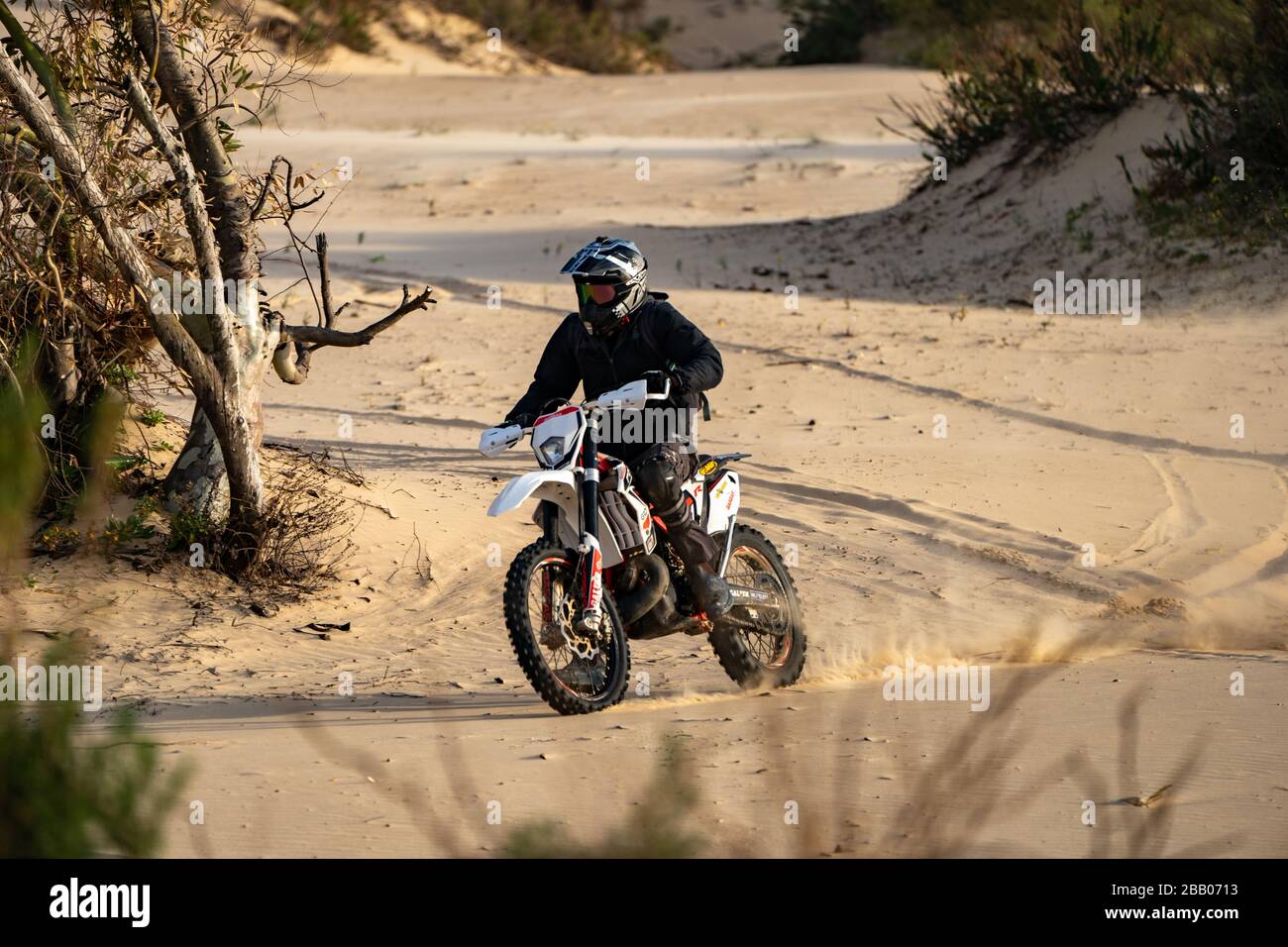 Dirt bike on a sand dune Stock Photo - Alamy