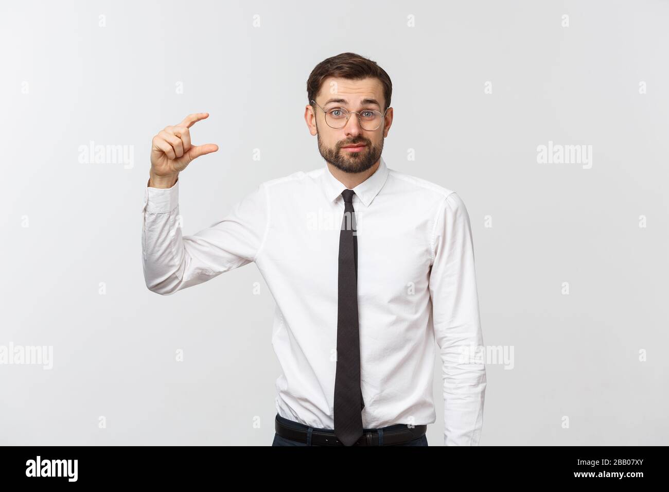 businessman making his fingers the small size. emotions, facial ...
