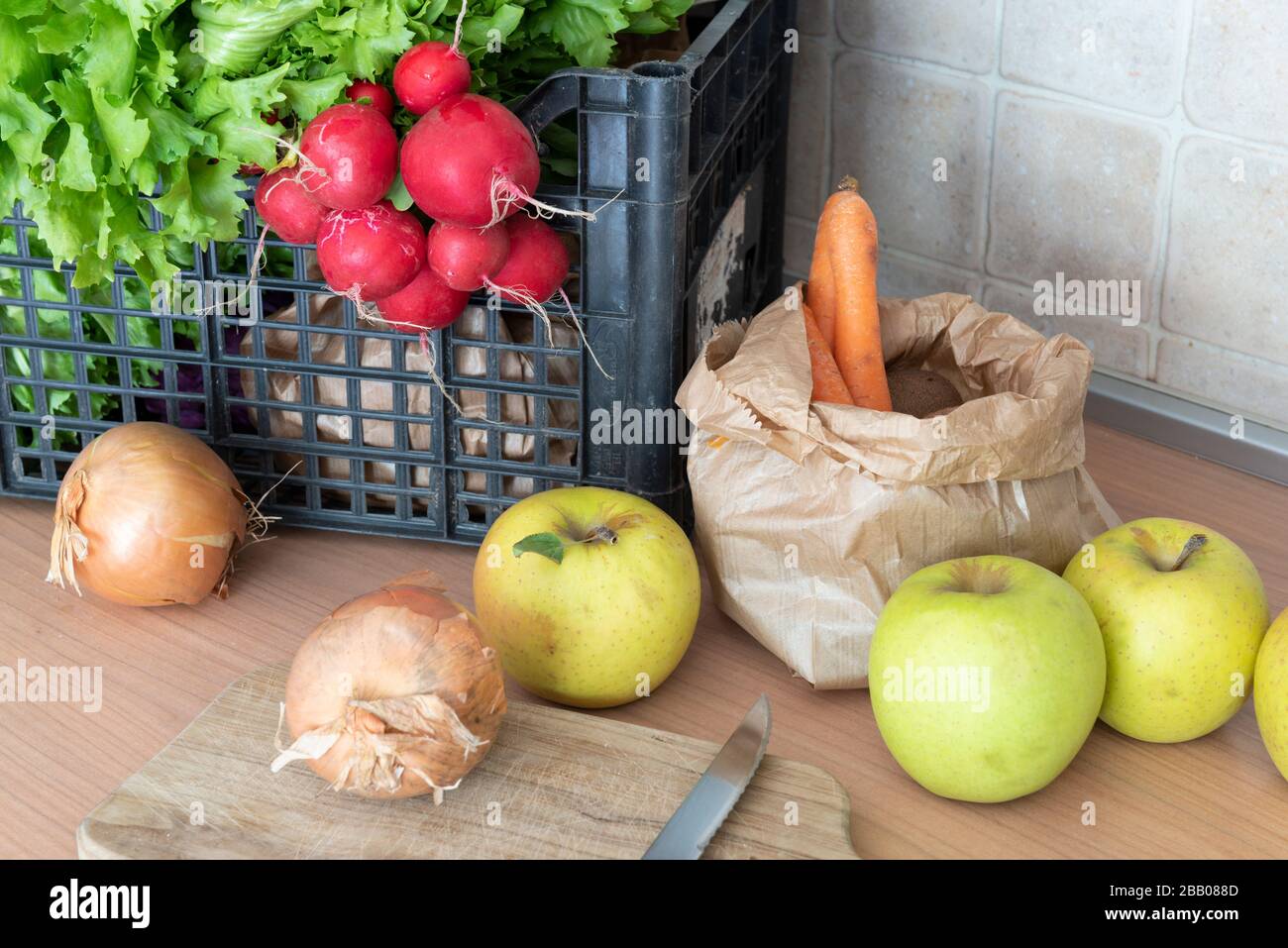 carrots organic vegetable in paper sachet, apples, radish and onions ...