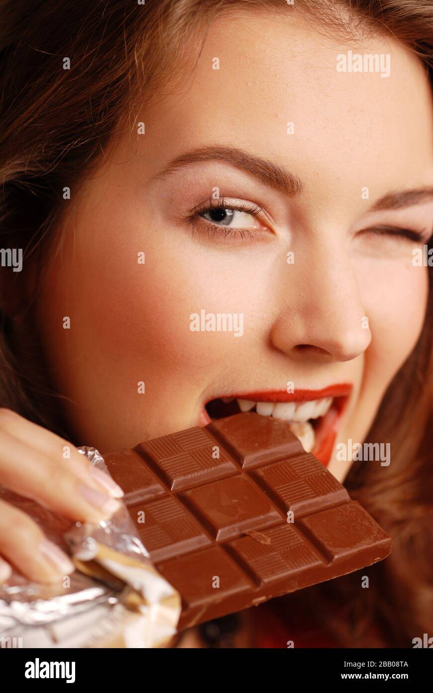 Pretty girl eating bar chocolate hi-res stock photography and images ...