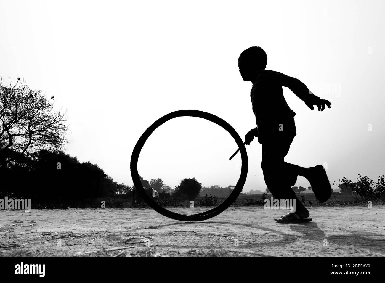 Indian boy playing tyre on hi-res stock photography and images - Alamy