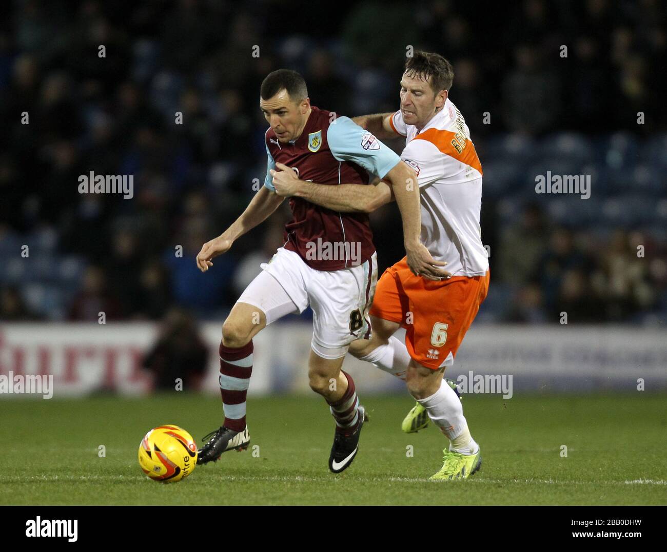 Blackpool's Kirk Broadfoot (right) and Burnley's Dean Marney battle for ...