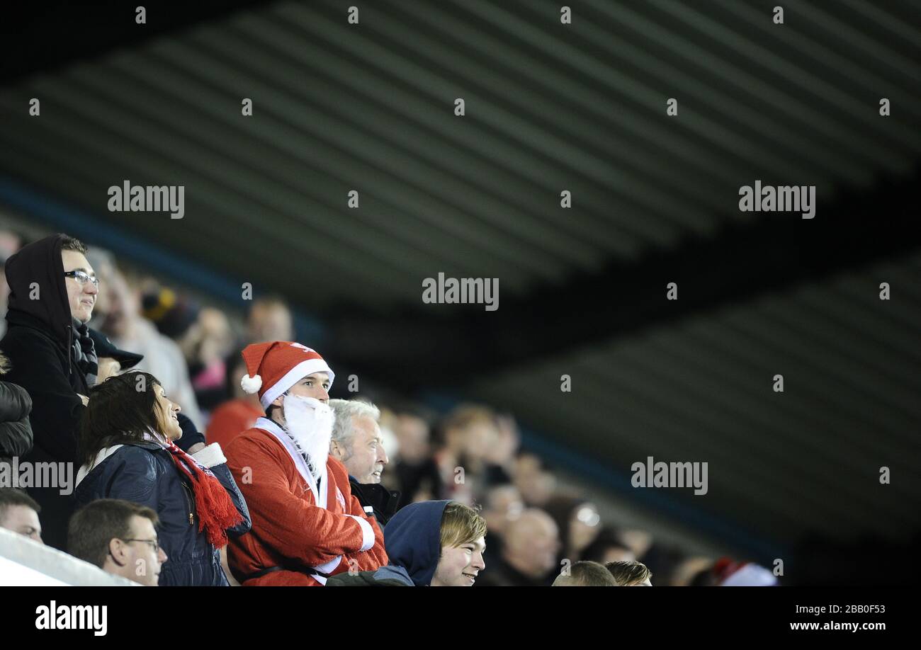 A fan dressed as santa in the stands hi-res stock photography and ...