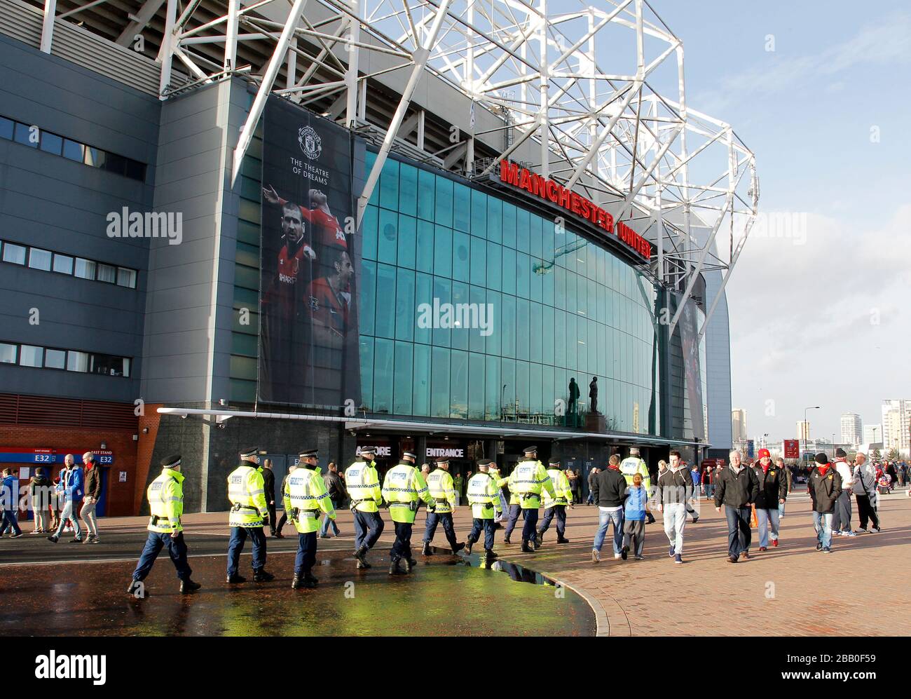 A general view as police officers walk past football fans outside Old ...