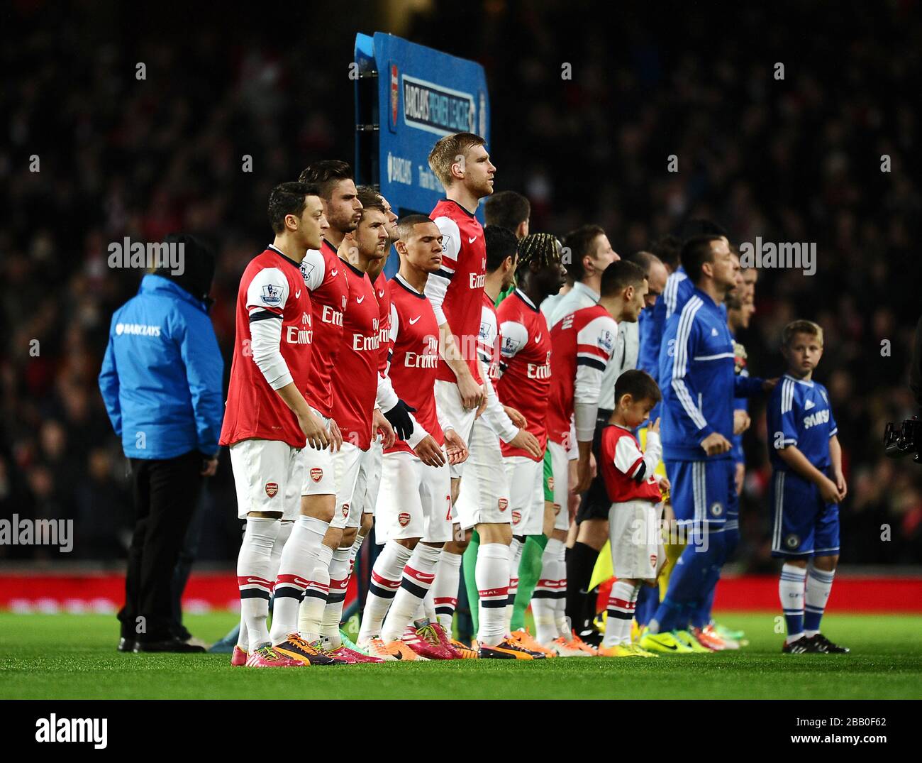 Arsenal and Chelsea players line up with the match day mascots Stock ...