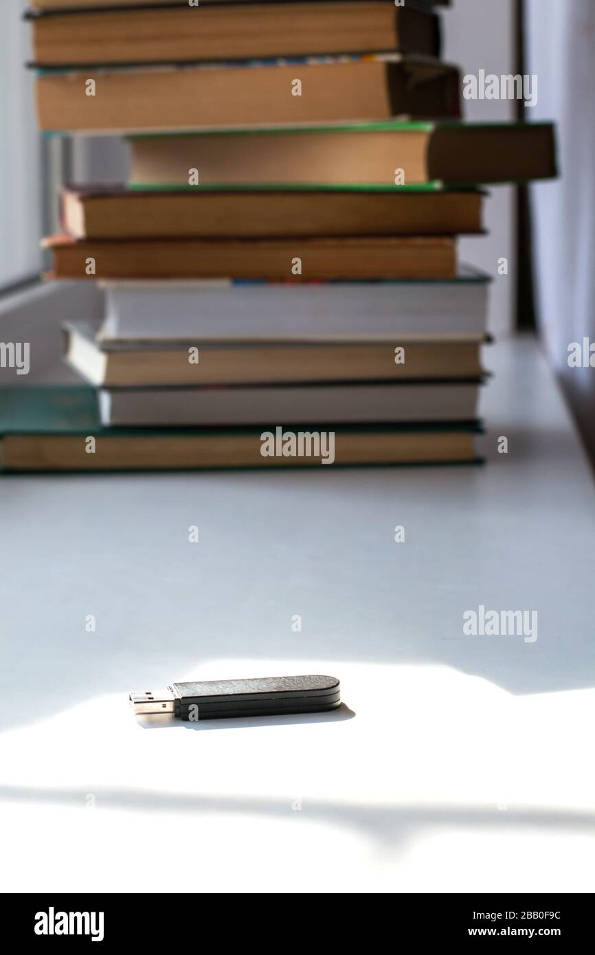Flash drive on the background of books, result of progress Stock Photo ...
