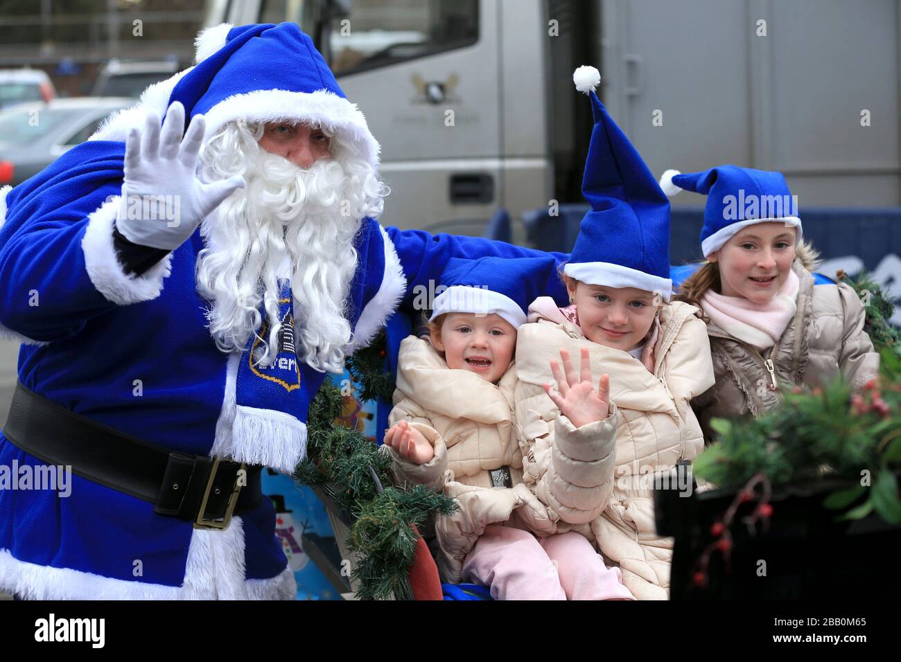 A blue Santa greets Everton fans in the fan zone before the game Stock ...