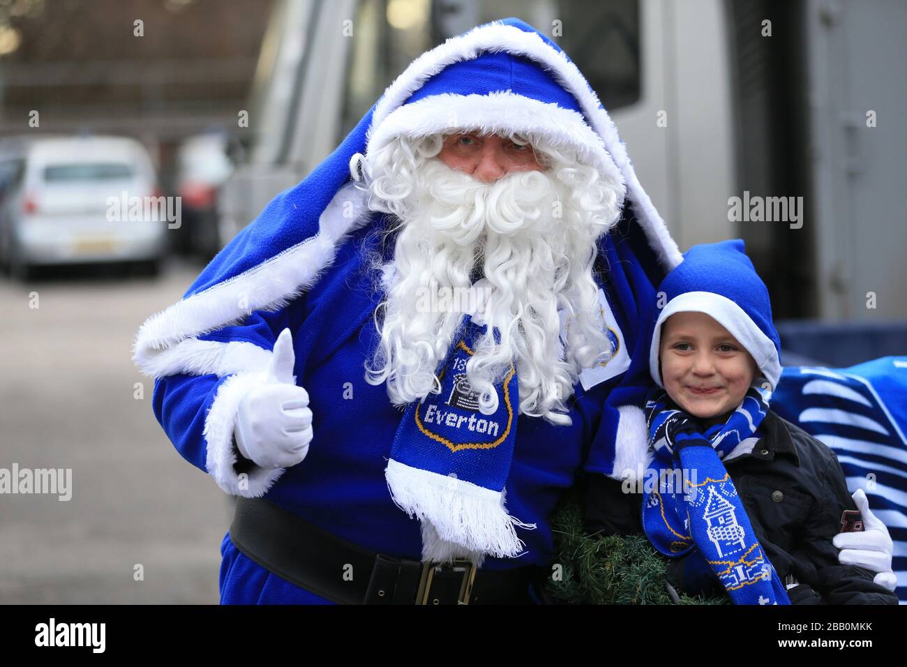 A blue Santa greets Everton fans in the fan zone before the game Stock ...