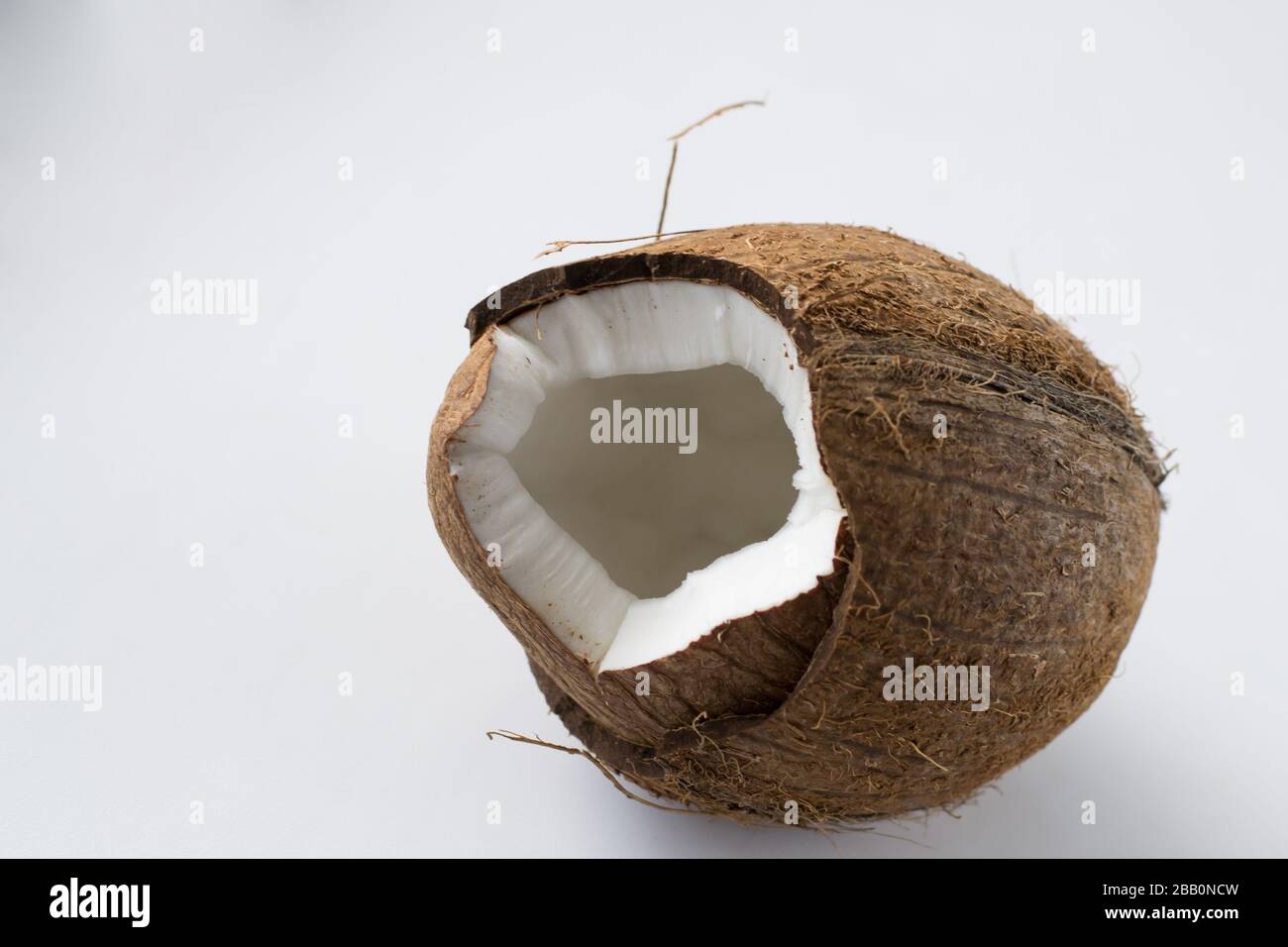 Close up of cracked coconut on white background Stock Photo - Alamy