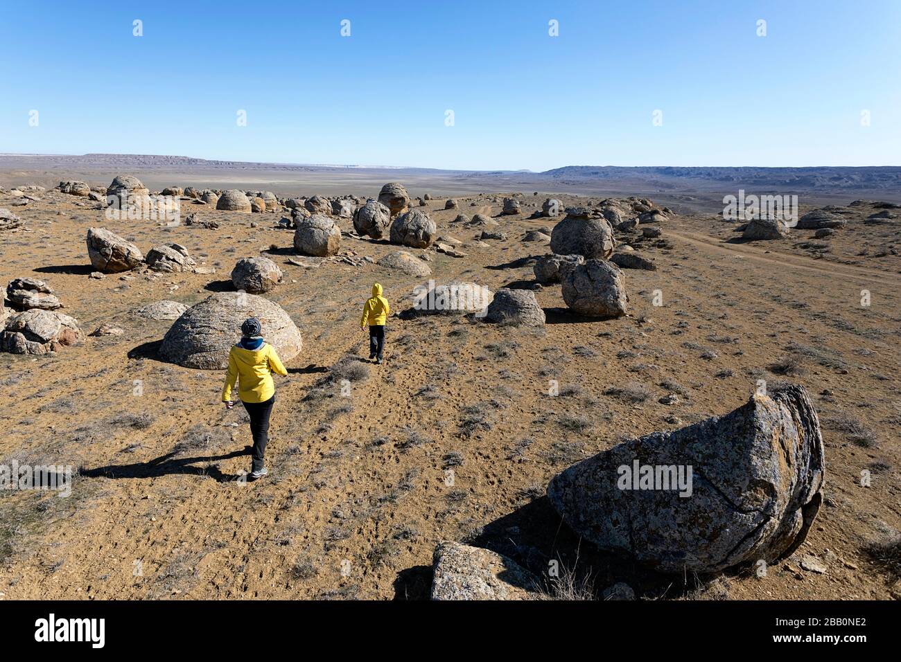 Mother and son discovering the valley of balls in western Kazakhstan ...