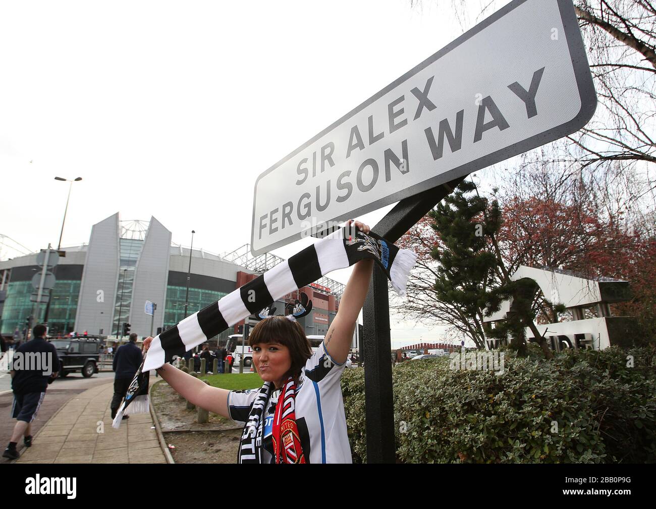A Newcastle United fan poses for a photograph on Sir Alex Ferguson Way ...