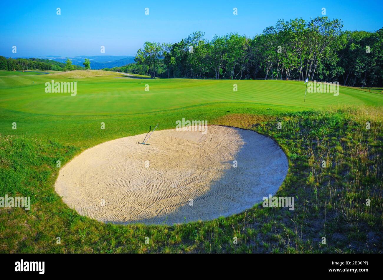 Nice golf course with bunker and nice green Stock Photo - Alamy