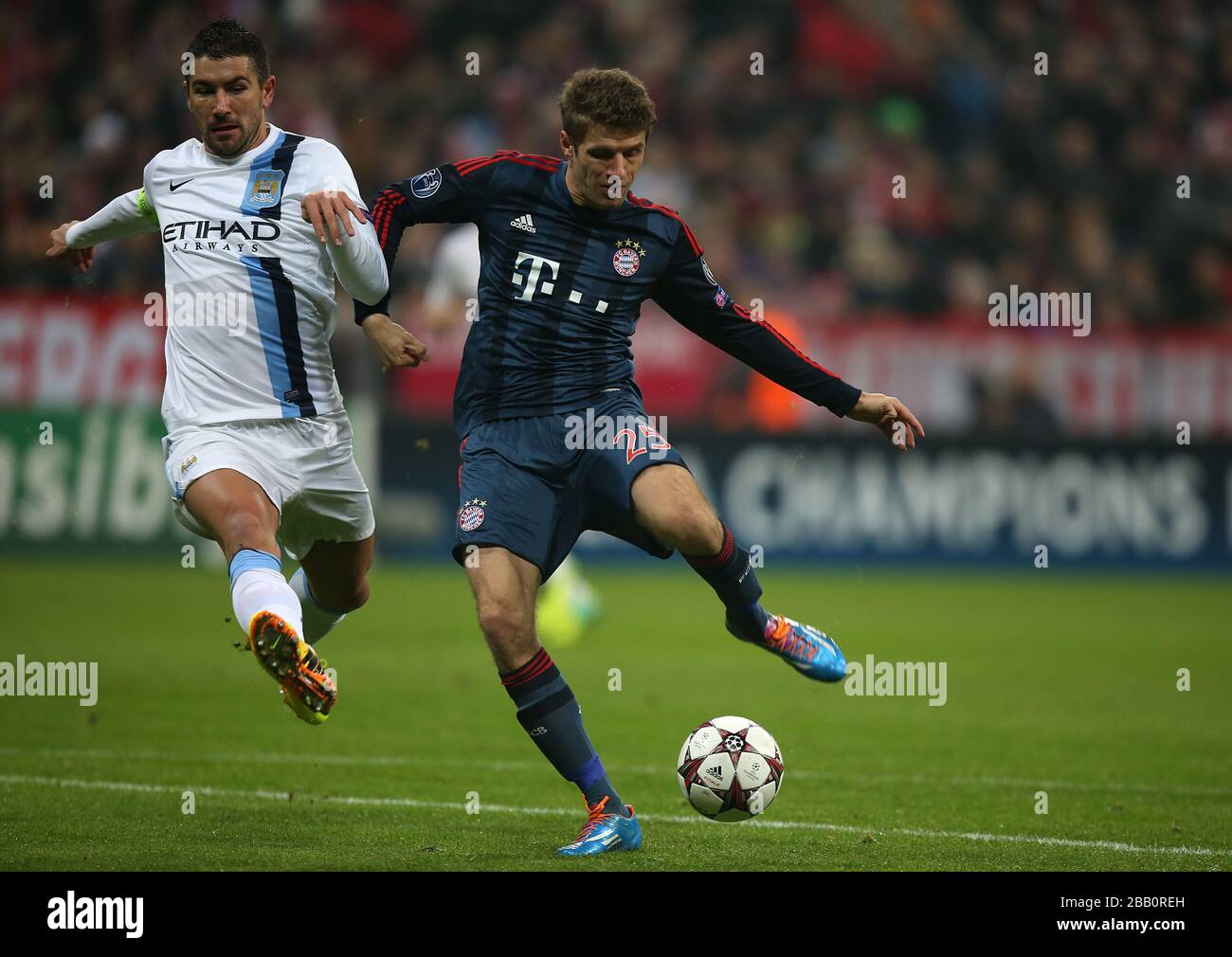 Bayern Munich's Thomas Muller (right) shoots to score his team's ...
