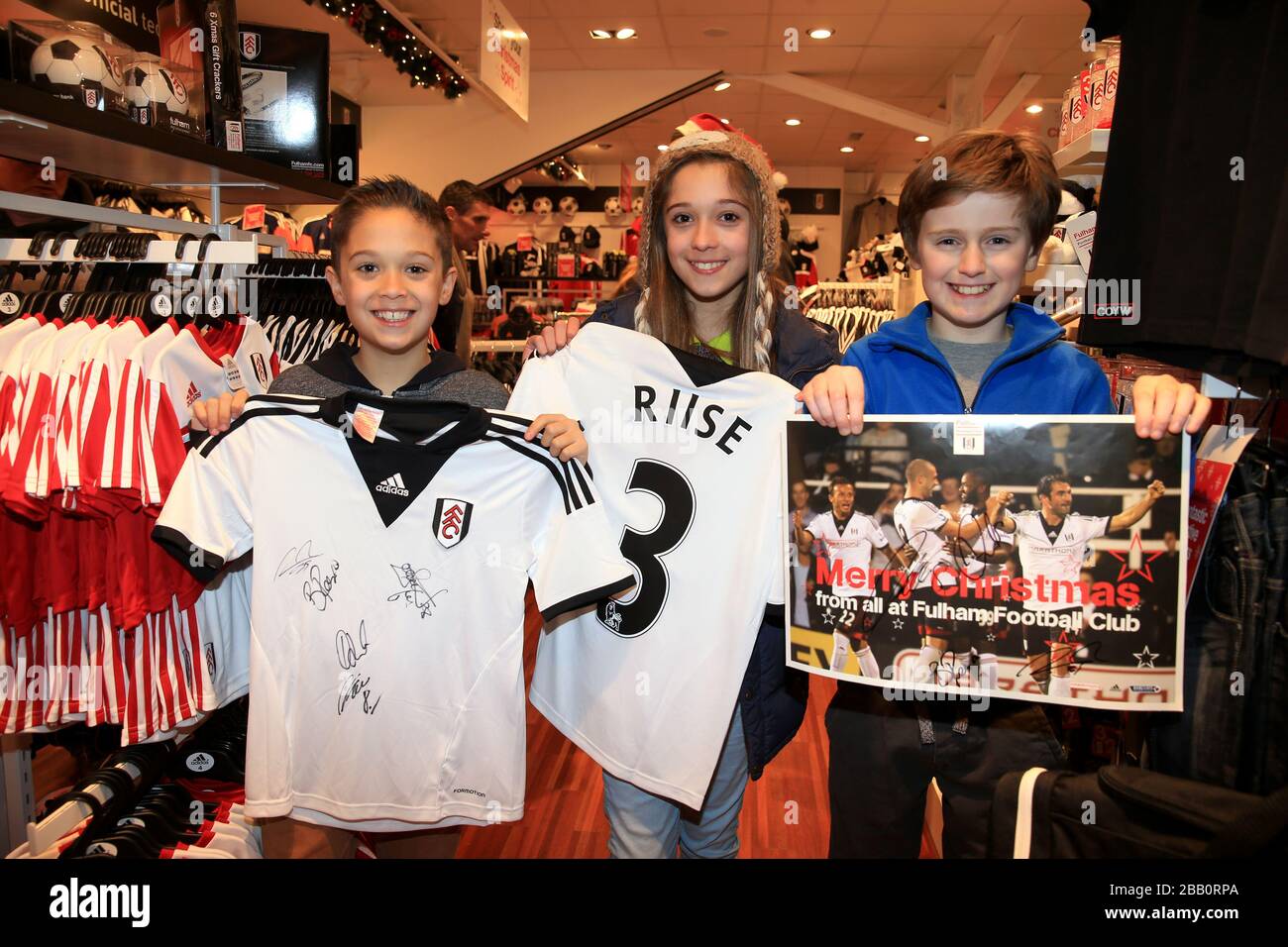 Young Fulham fans pose for a photo in the club shop during the ...