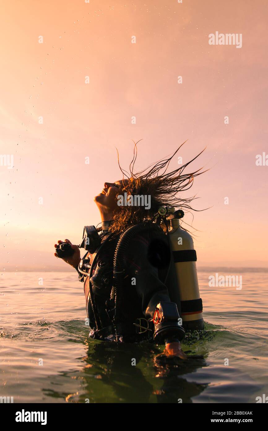 Female Scuba Dive Instructor Wearing a Dry Suit, a Twin Tank and ...