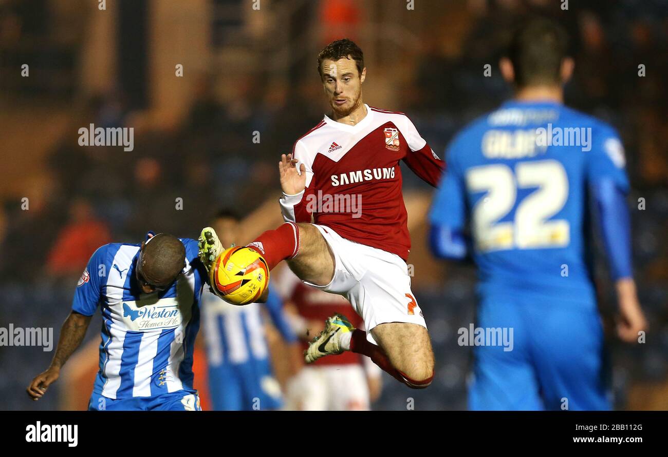 Swindon Town's Ryan Harley controls the ball ahead of Colchester United ...