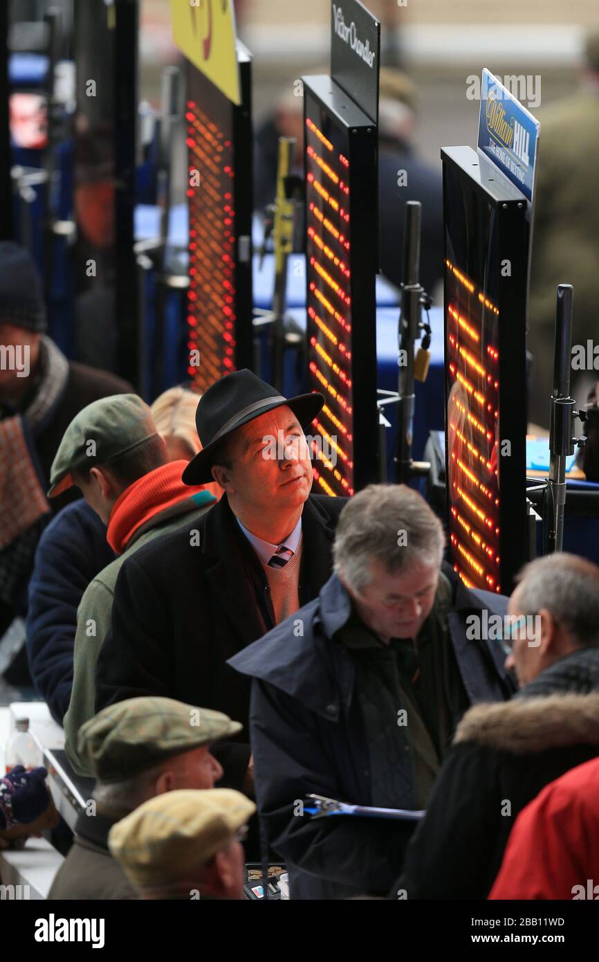 Racegoers look at electronic betting stands at Cheltenham Stock Photo ...