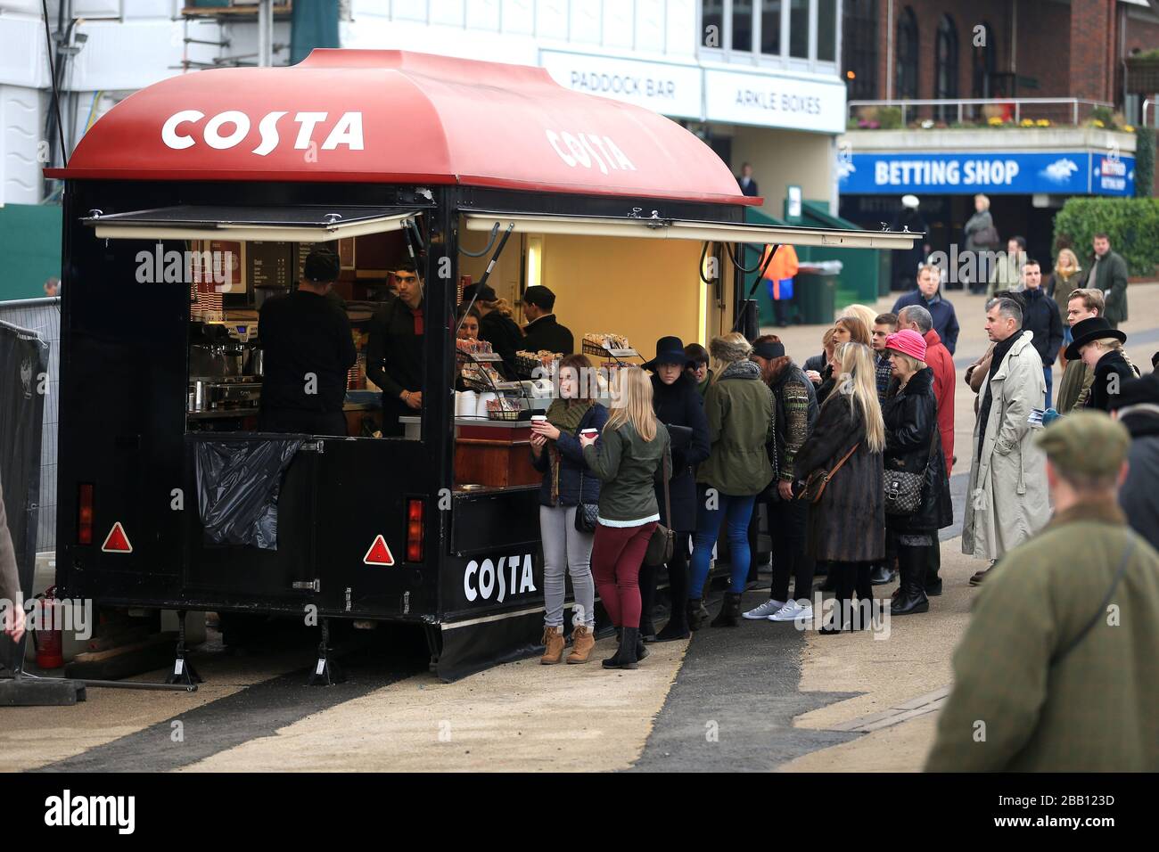 Racegoers queue at a Costa coffee stand at Cheltenham Racecourse Stock ...