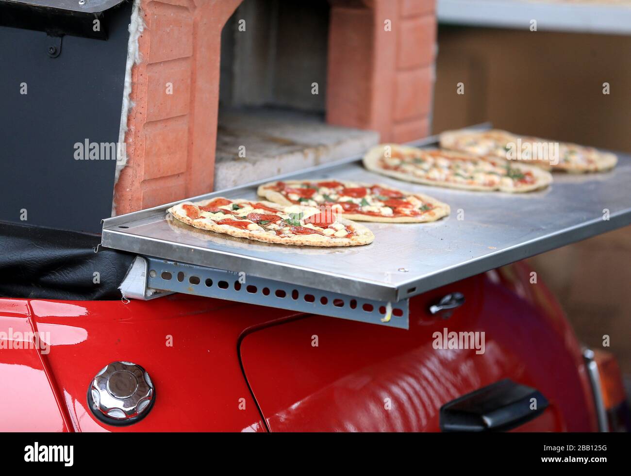 General view of a pizza oven in a converted Mini car Stock Photo - Alamy