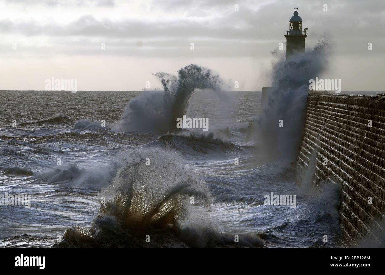 Waves break against pier tynemouth hi-res stock photography and images ...