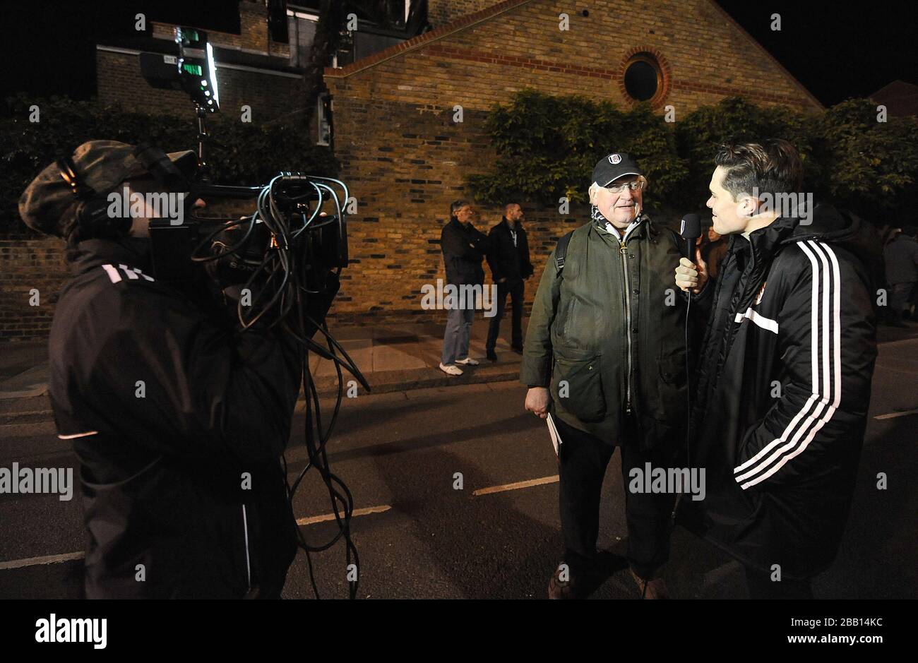 Fulham TV interview fans Stock Photo - Alamy