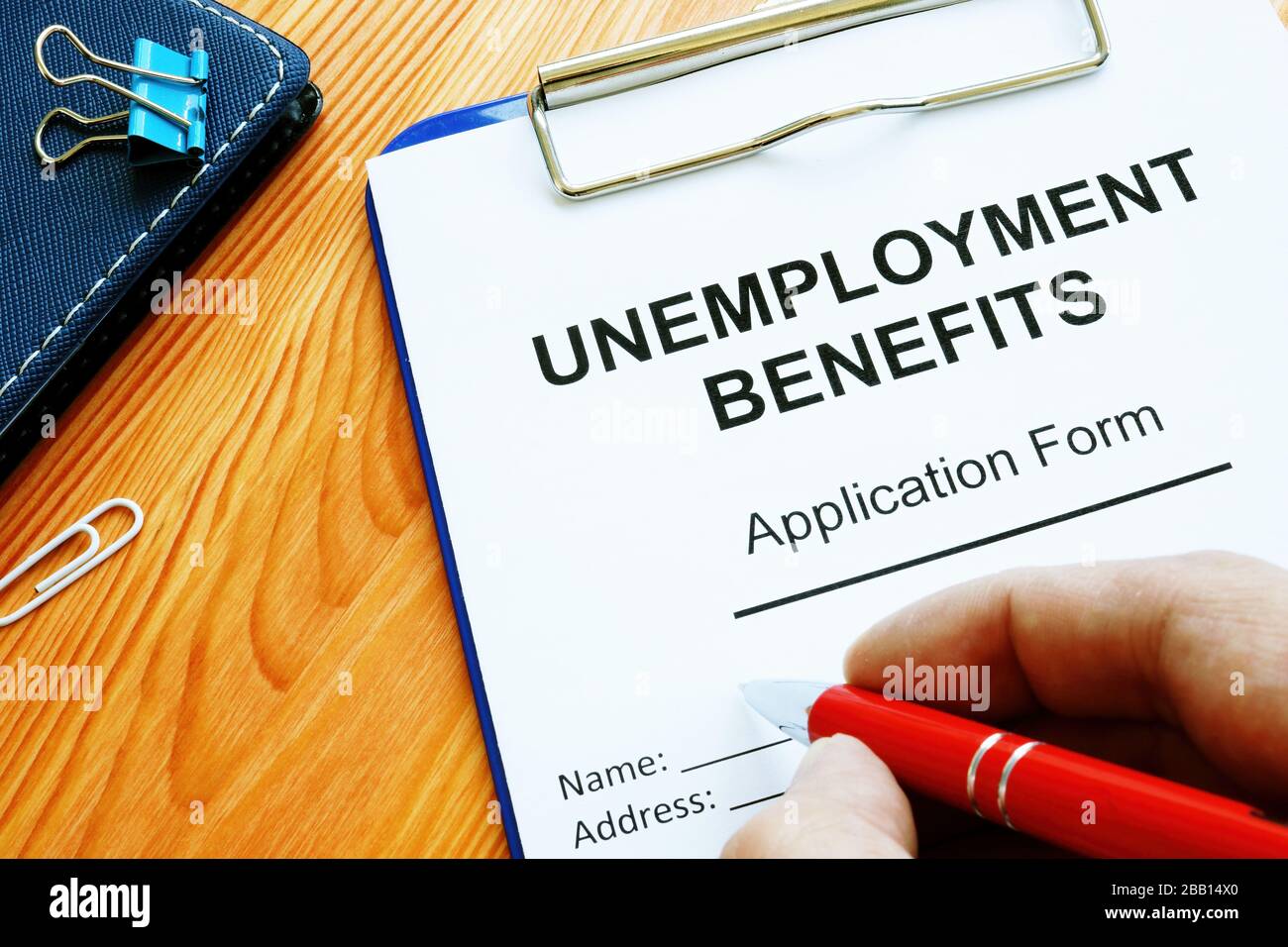 Man fills in Unemployment benefits application form Stock Photo - Alamy