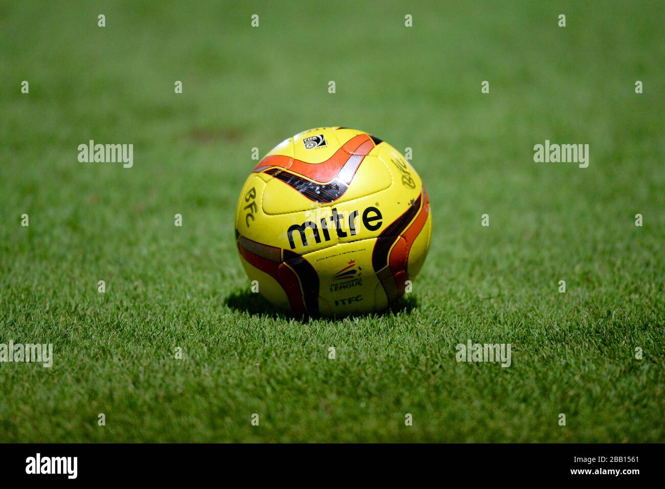 A yellow mitre ball on the pitch Stock Photo - Alamy