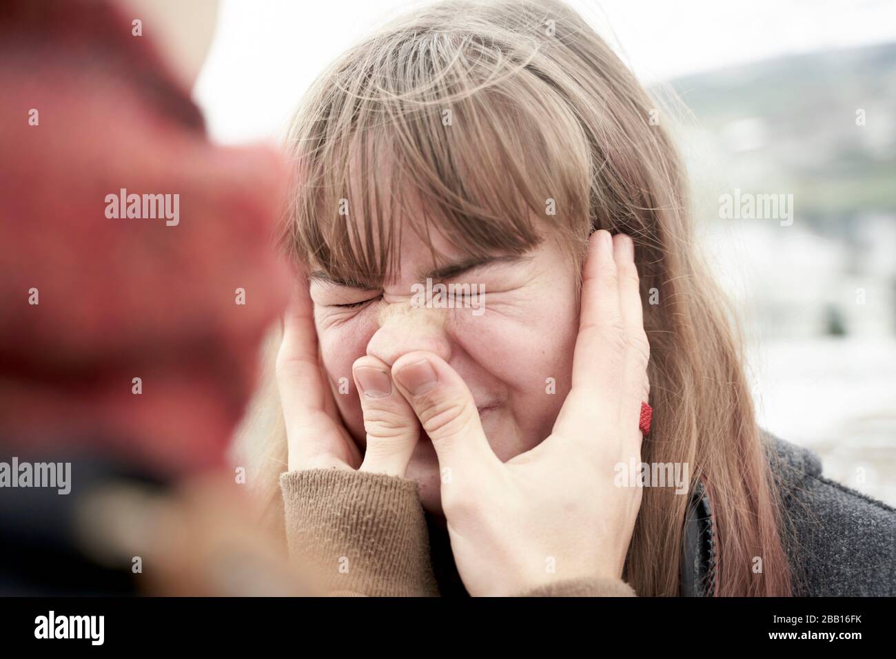 male hands squeezing face of woman, pressure Stock Photo - Alamy