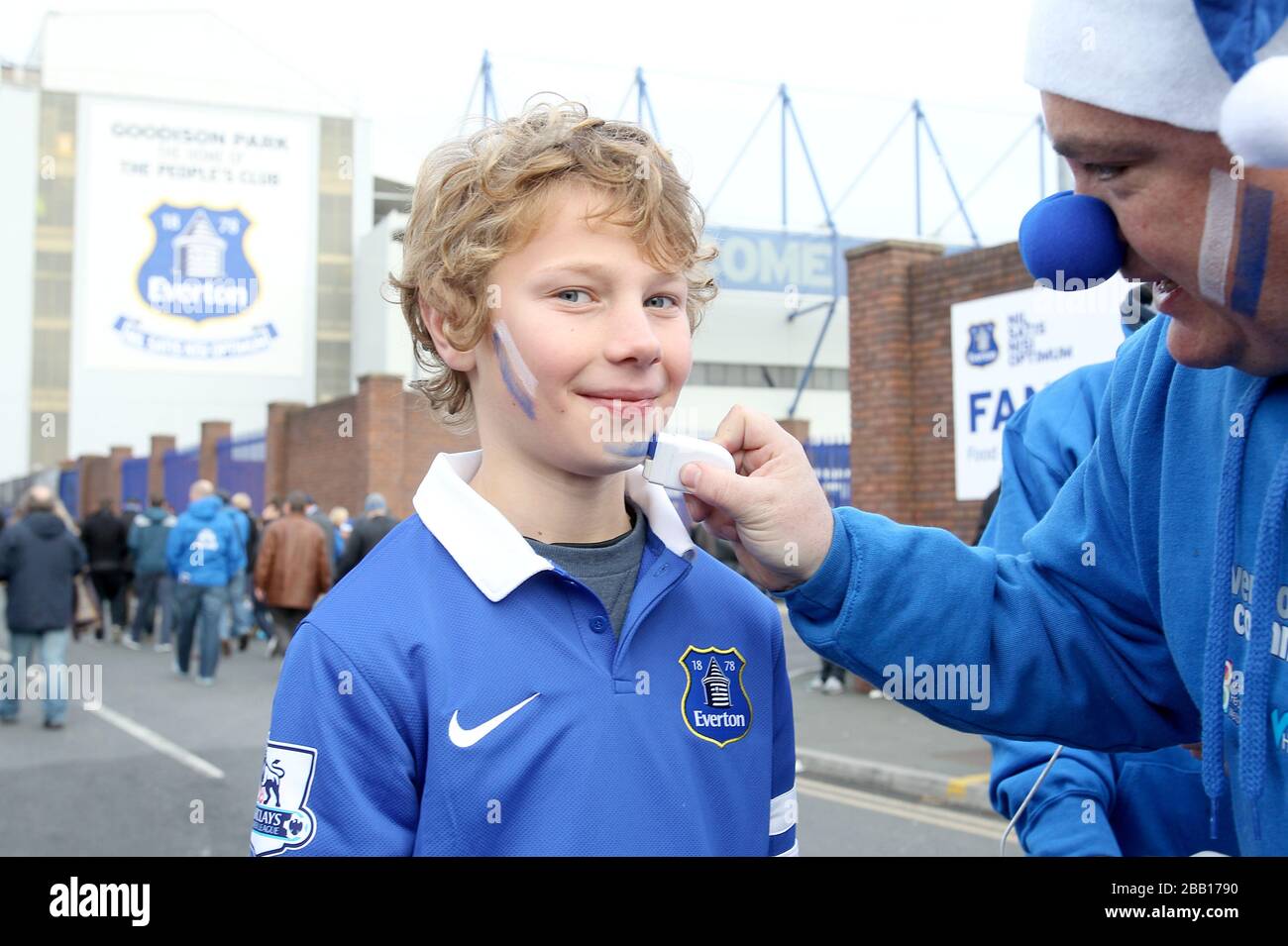 A young Everton fan has his face painted outside Goodison Park before ...