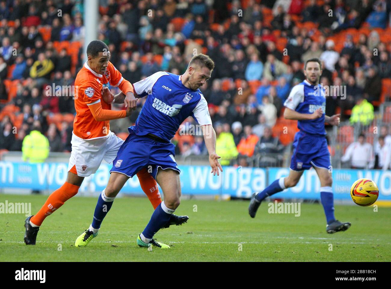 Blackpool's Tom Ince (left) in action with Ispwich Town's Luke Chambers ...