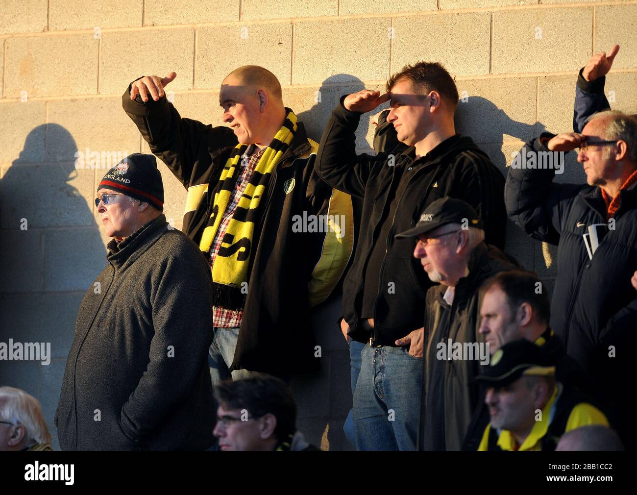 Burton Albion fans shield their eyes from the sun Stock Photo - Alamy