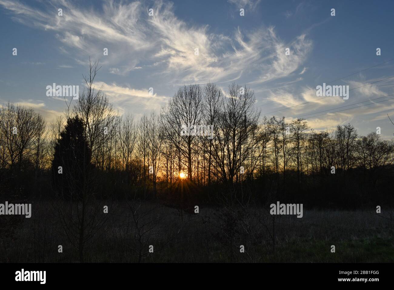 A stunning blue sky enveloped in an orange sunset, revealed through the ...