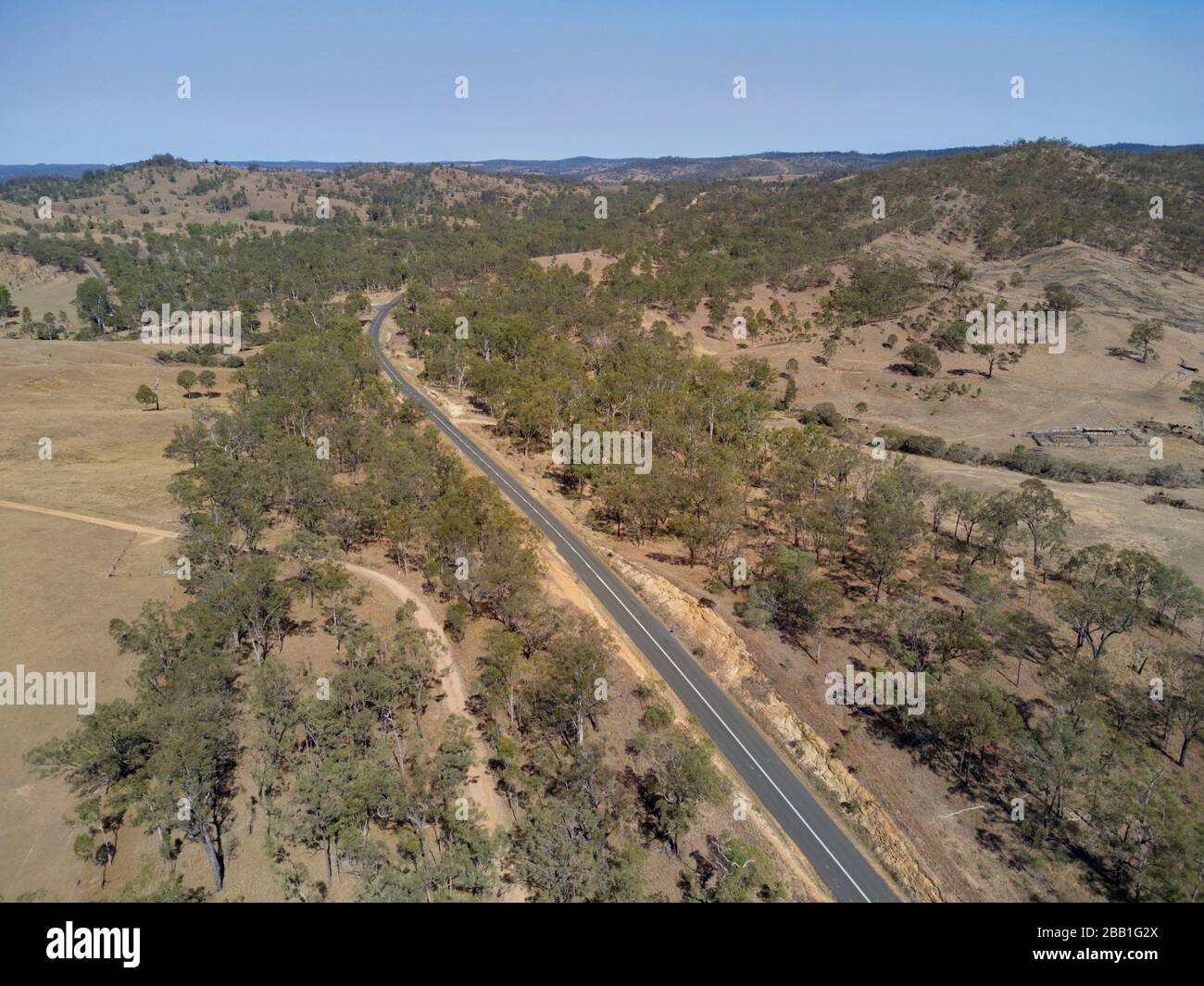 Aerial of sealed country road passing through drought affected ...