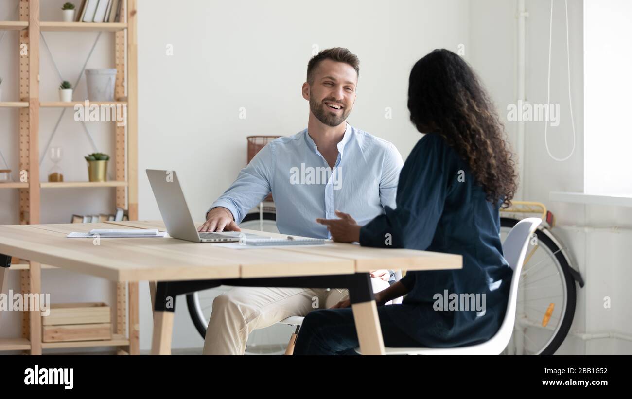 Two diverse colleagues smile hi-res stock photography and images - Alamy