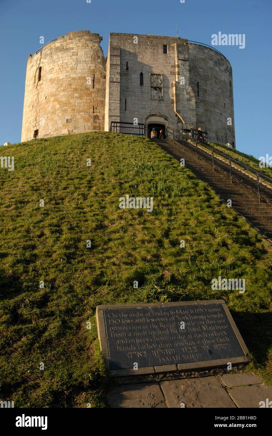A medieval tower sits on a small hill is Clifford's Tower in York ...