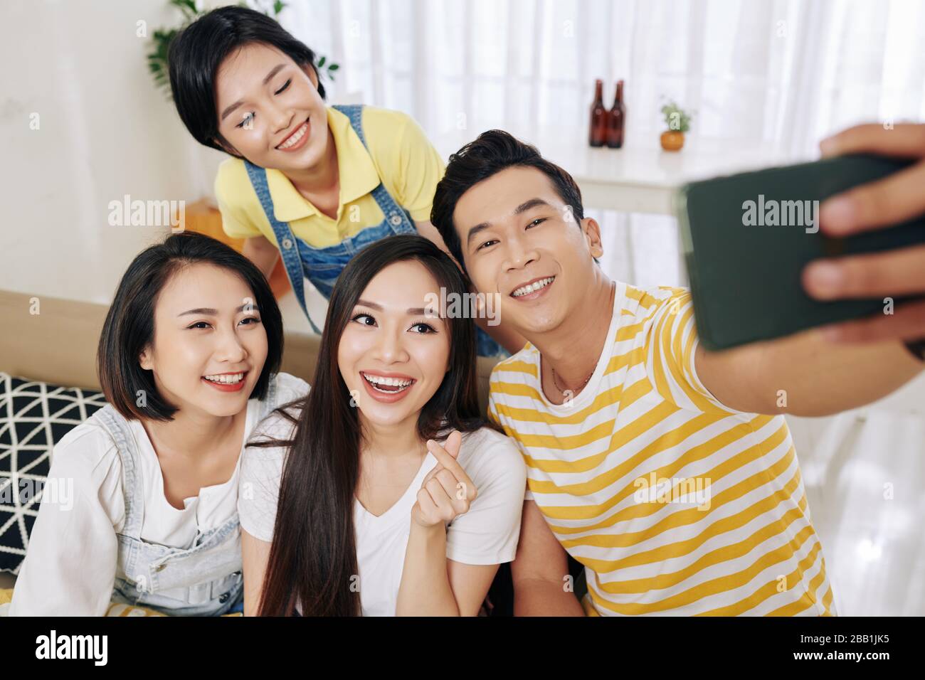 Happy group friends making heart hi-res stock photography and images ...