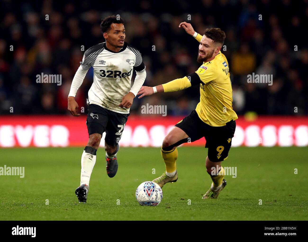 Derby County's Max Lowe (left) and Millwall's Tom Bradshaw battle for ...