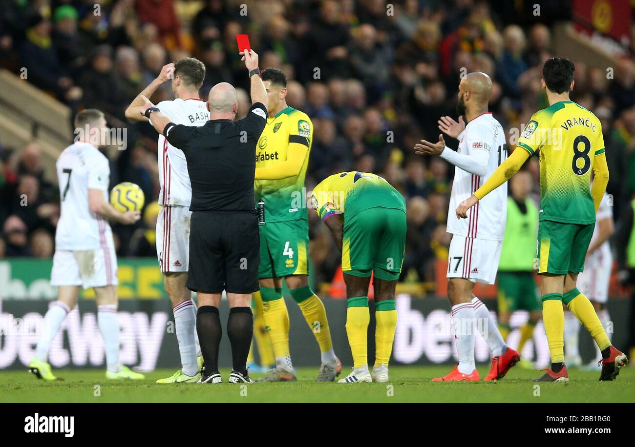 Sheffield United's Chris Basham is shown a red card by match referee ...