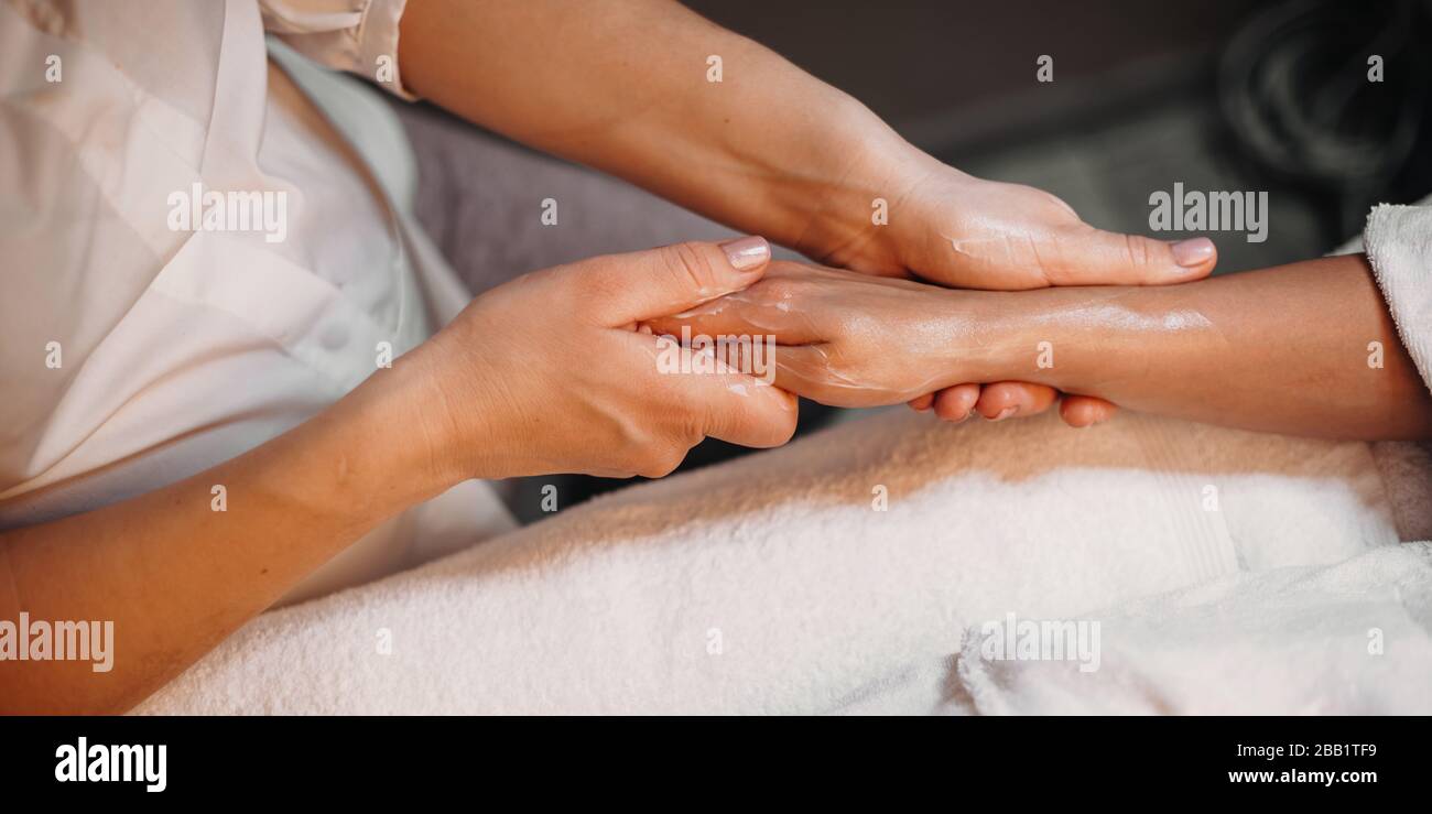 Hand massage session with special cream done at the spa salon to a ...
