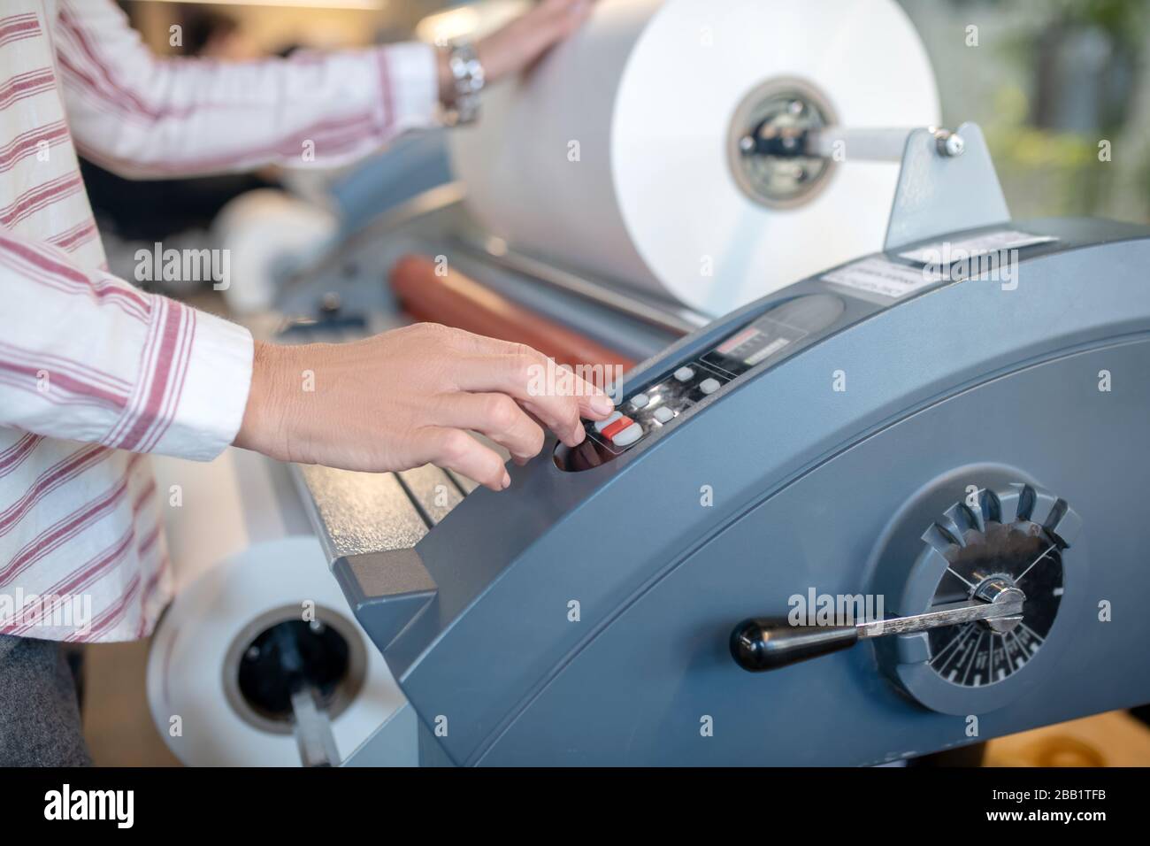 Female hands, pushing buttons, adjusting paper roll machine Stock Photo ...