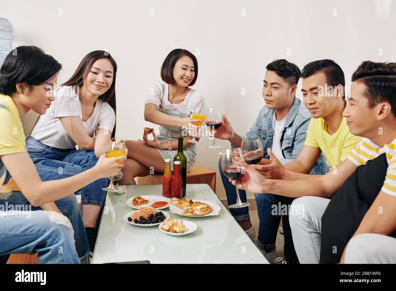 Group of Vietnamese young people talking, having drinks and food at ...
