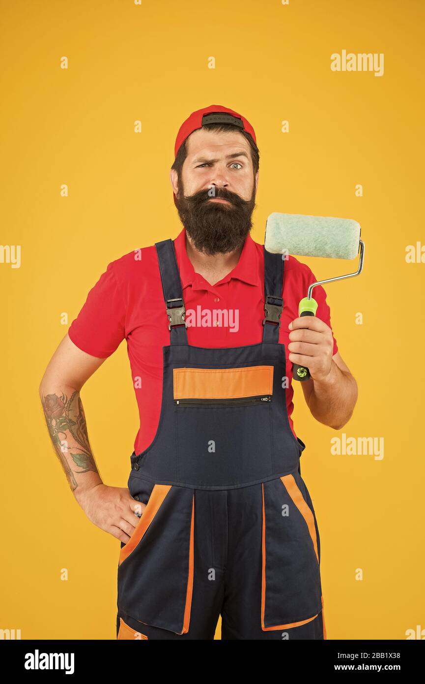 making house renovation. hipster builder in cap yellow background ...