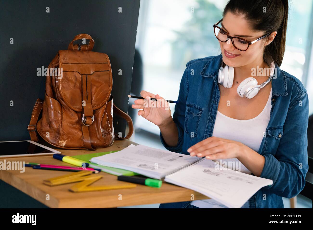 Pretty young college student studying, preparing for exam Stock Photo ...